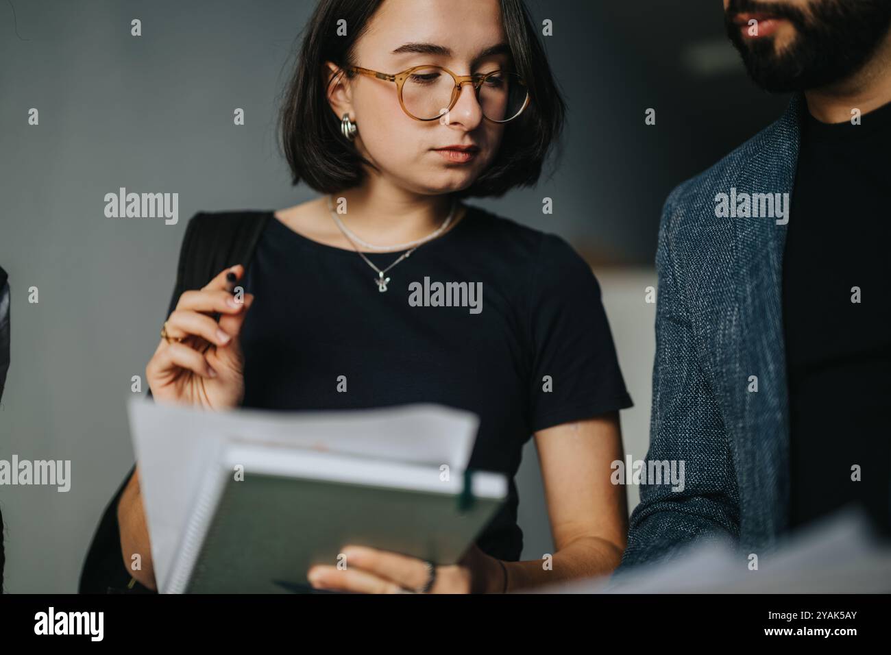 Students discussing academic materials with professor between classes ...