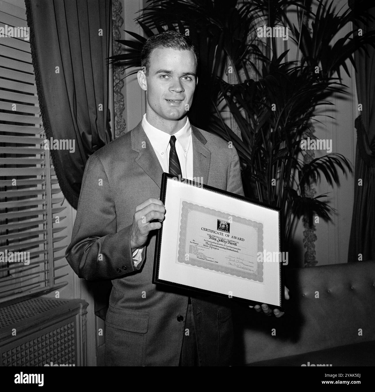 Jeff Farrell, Olympic swimmer from Wichita, Kan., displays the T. Kirby ...