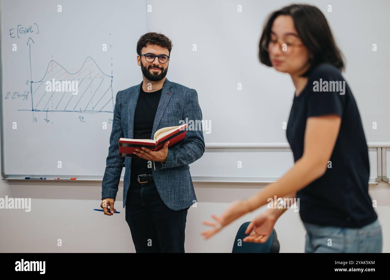 Teacher engaging with students in a dynamic classroom setting Stock ...