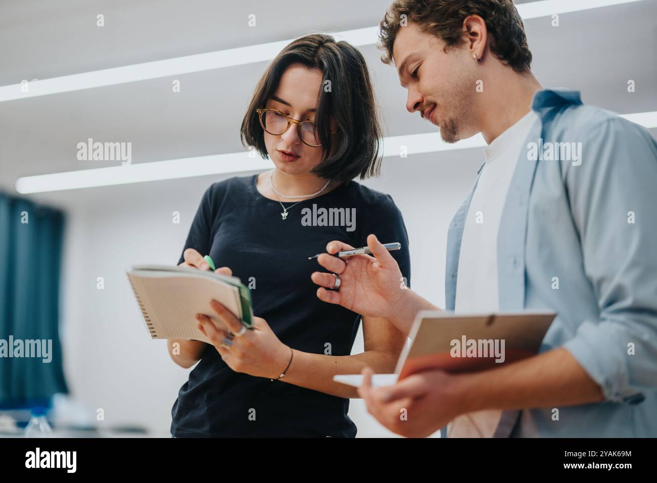 Students collaborating on a classroom assignment in modern school ...