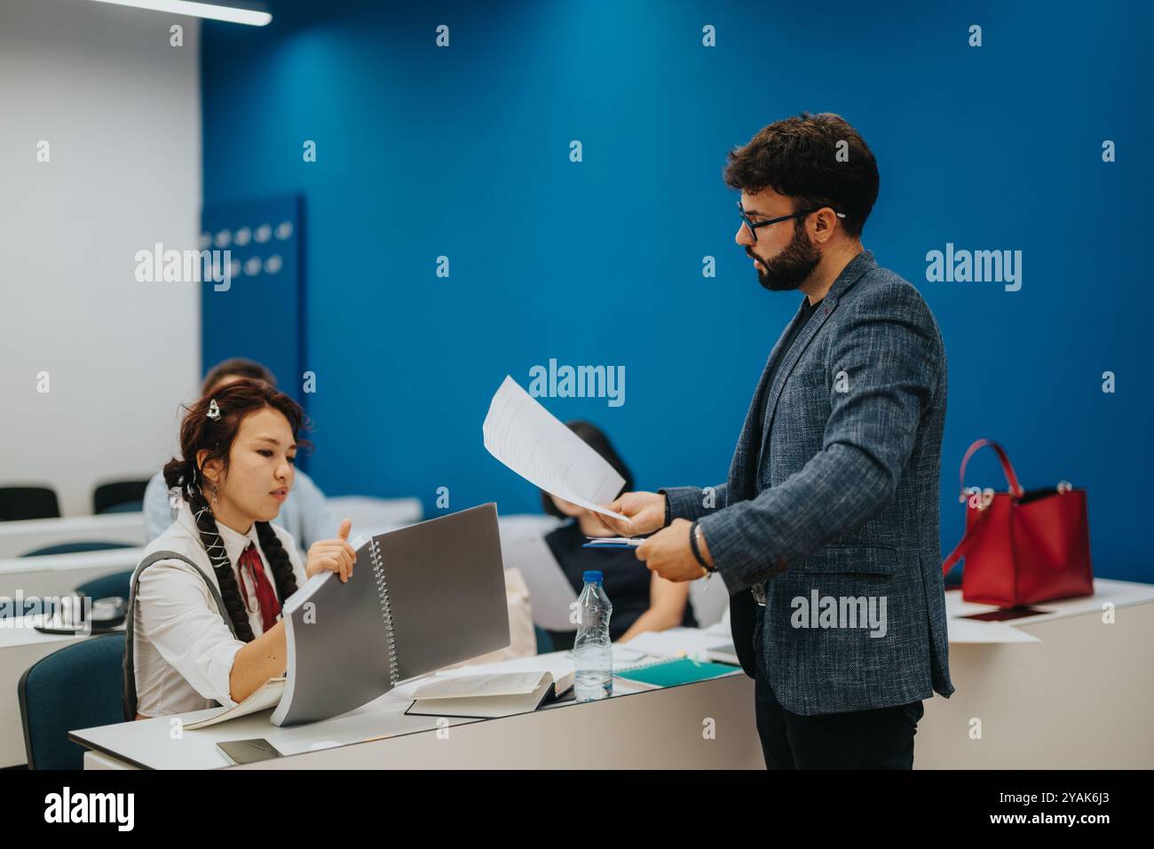 Teacher engaging with students during classroom learning session Stock ...