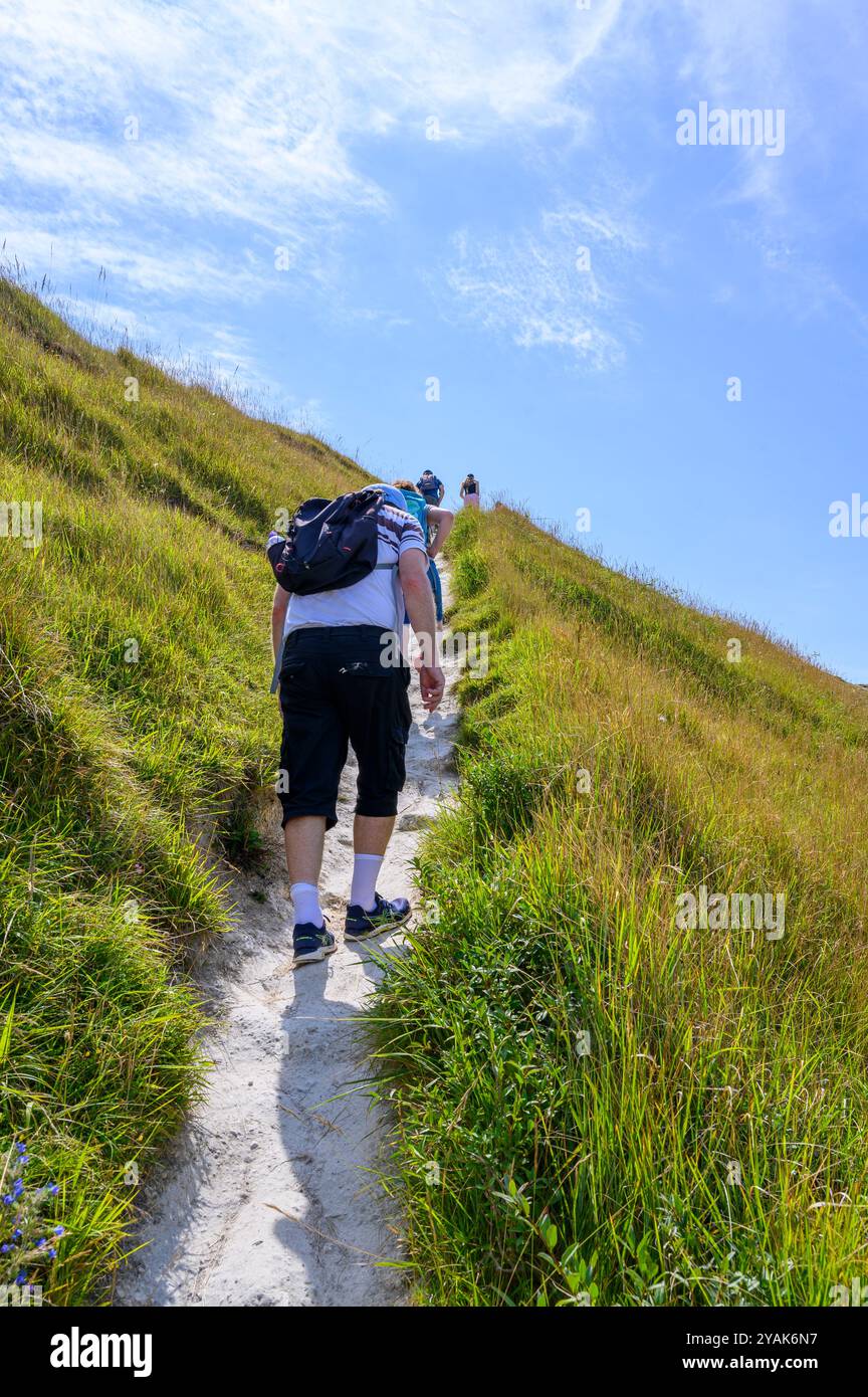 A group of people walk the very steep chalk path up to Haven Brow, the ...