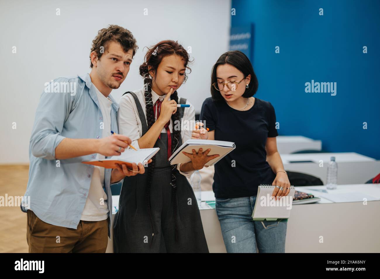 Diverse group of students involved in classroom discussion Stock Photo ...