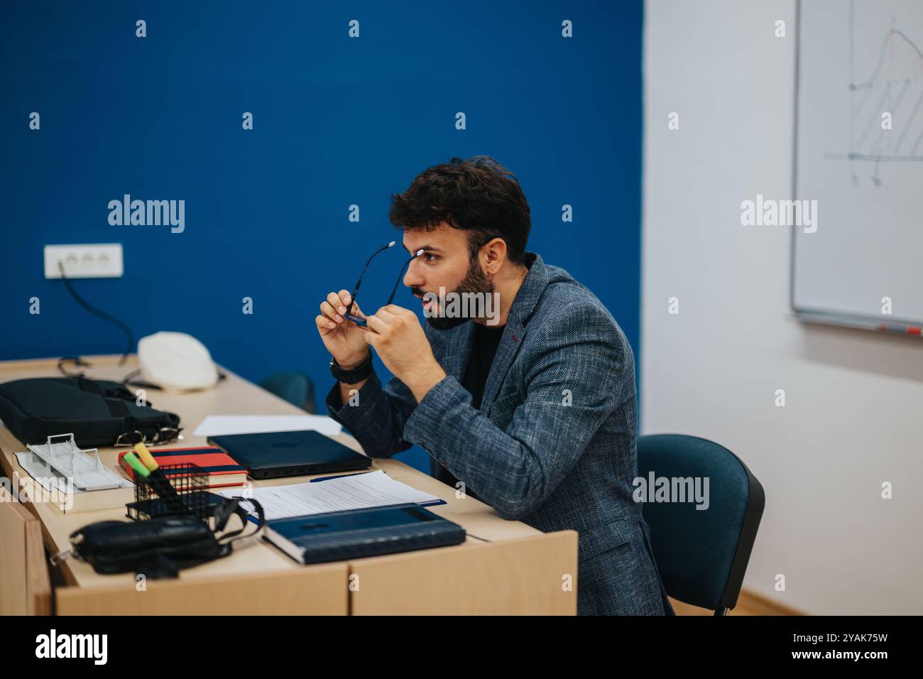 Focused student preparing for a class presentation in a classroom ...