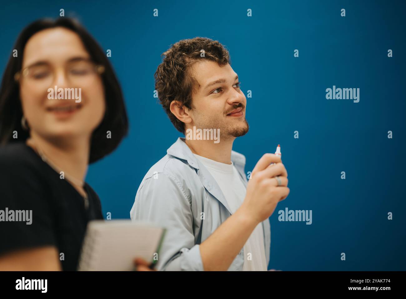 Two students engaged in a collaborative classroom setting Stock Photo ...