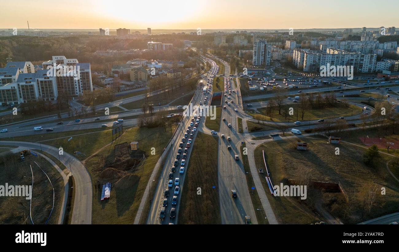 Aerial view of a busy highway interchange at sunset with traffic ...