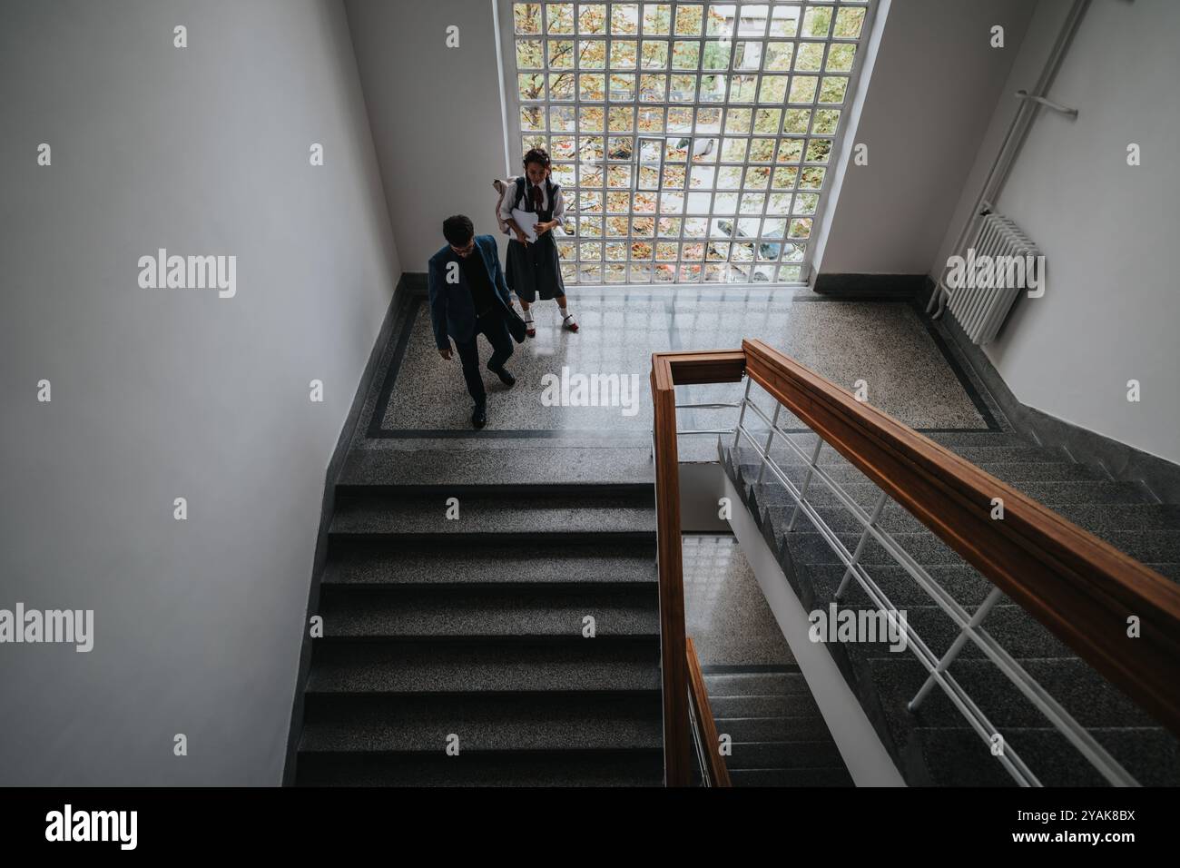 Two students walking up a staircase in a school building Stock Photo ...