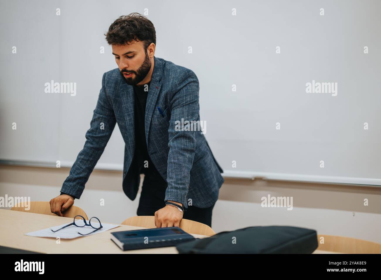 Professor engaging in discussion with students in classroom setting ...