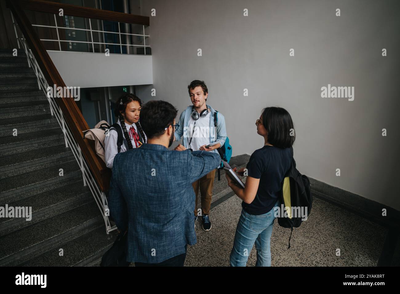 Students and professor discussing together in a campus stairwell Stock ...