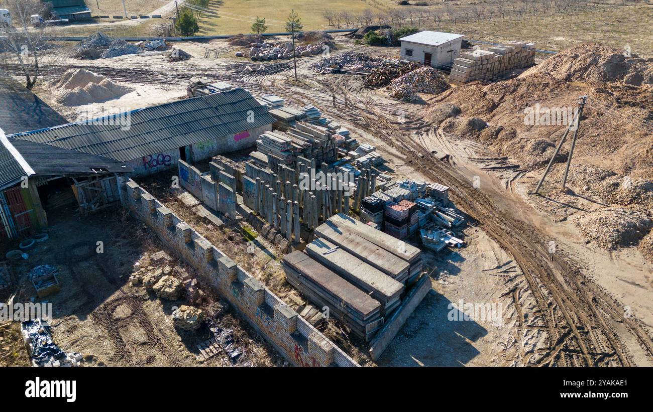 Aerial view of a stacks of old concrete slabs storage site, dirt piles ...
