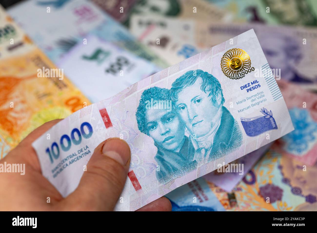 Argentina money, 10,000 Argentine pesos banknote held in hand against ...