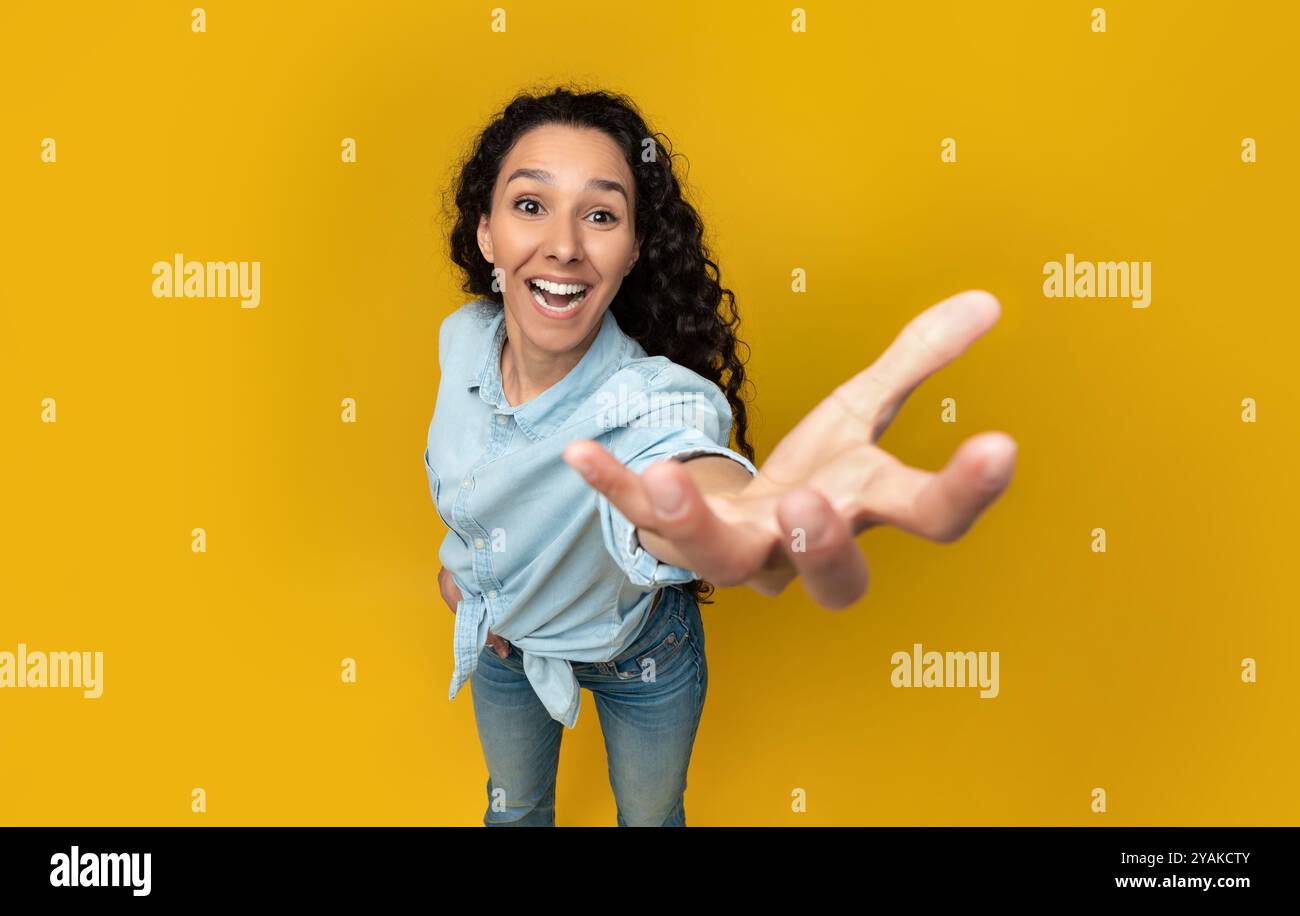 Excited young woman outstretching hand, trying to grab something Stock ...