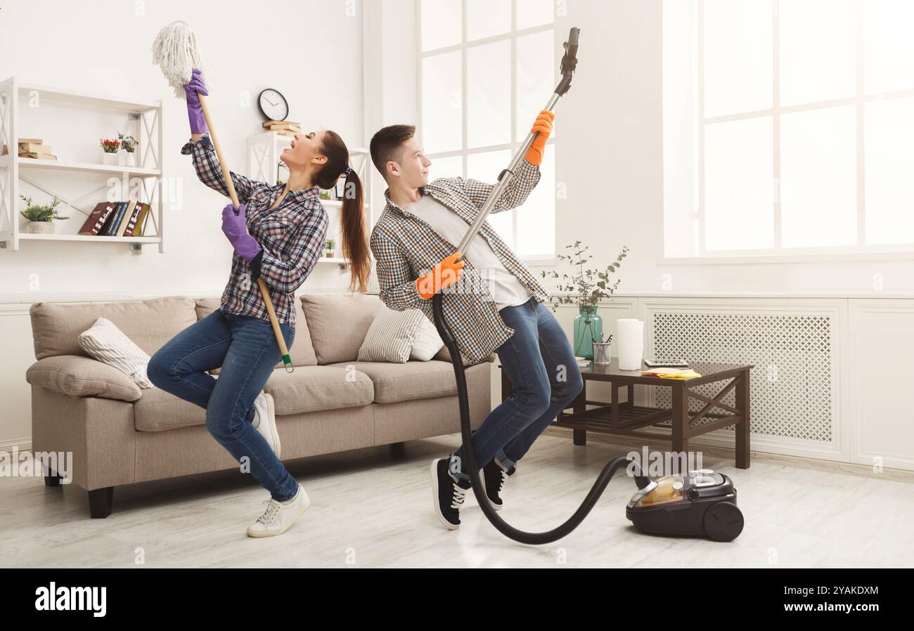Young couple cleaning home, having fun Stock Photo - Alamy