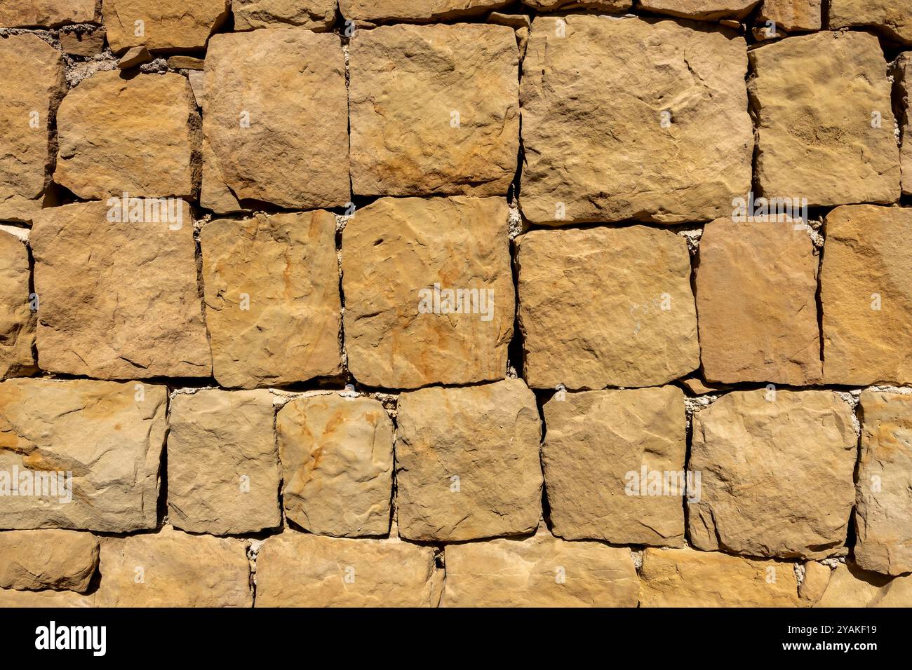 Large sandstone block patterned brick wall closeup background and ...