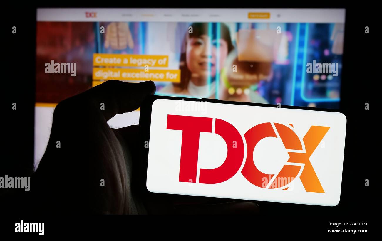 Person holding mobile phone with logo of Singaporean customer ...