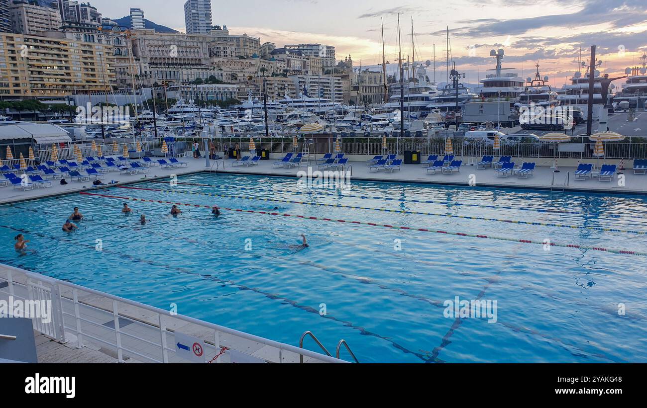 Swimming pool next to port Hercule in Monaco. Pink sunrise now -Elderly ...