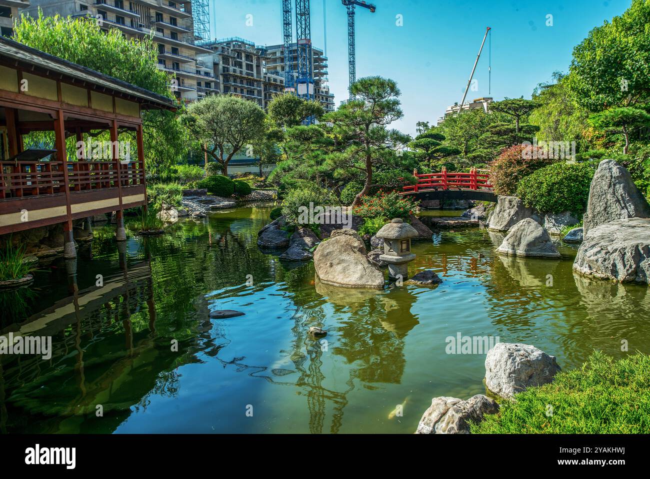 Amazing landscape in Japanese garden of Monaco with pond , larhe rocks and red pond and part of ...