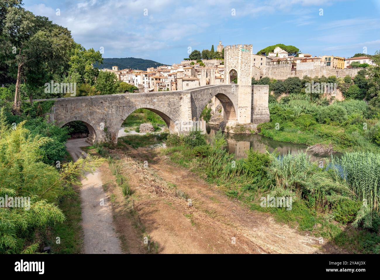 River under a medieval bridge with several arches that give access to a ...
