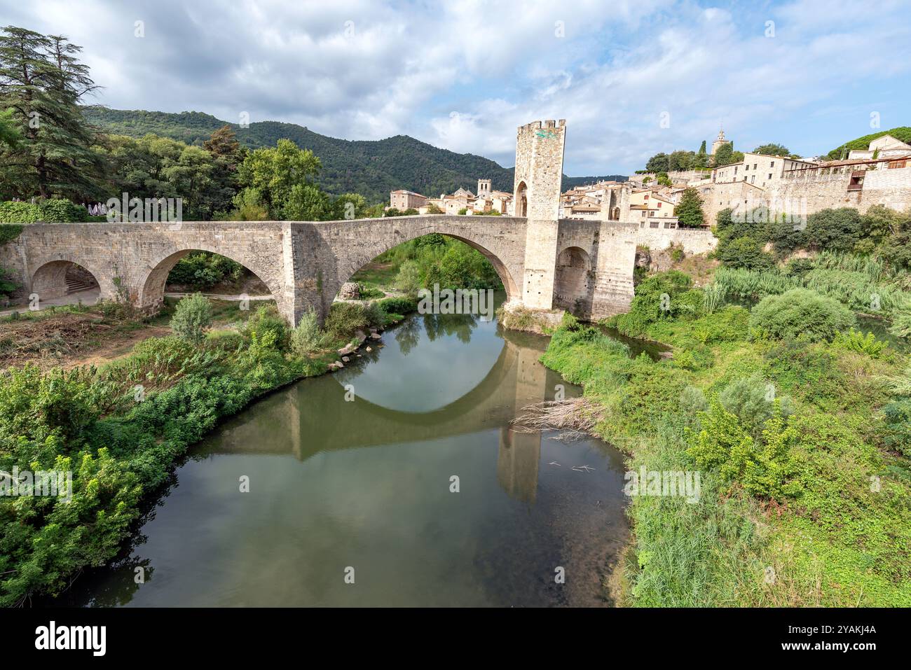 River under a medieval bridge with several arches that give access to a ...