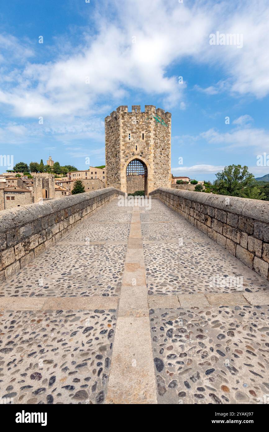 Top of a cobbled bridge that at the end has access to a tower that is ...
