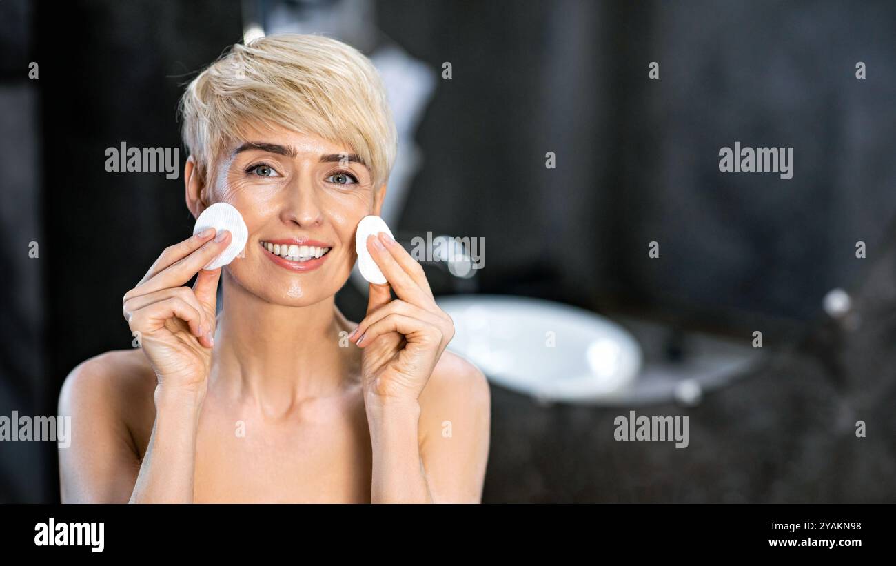 Lady Holding Cotton Pads Near Face Smiling Standing In Bathroom Stock ...