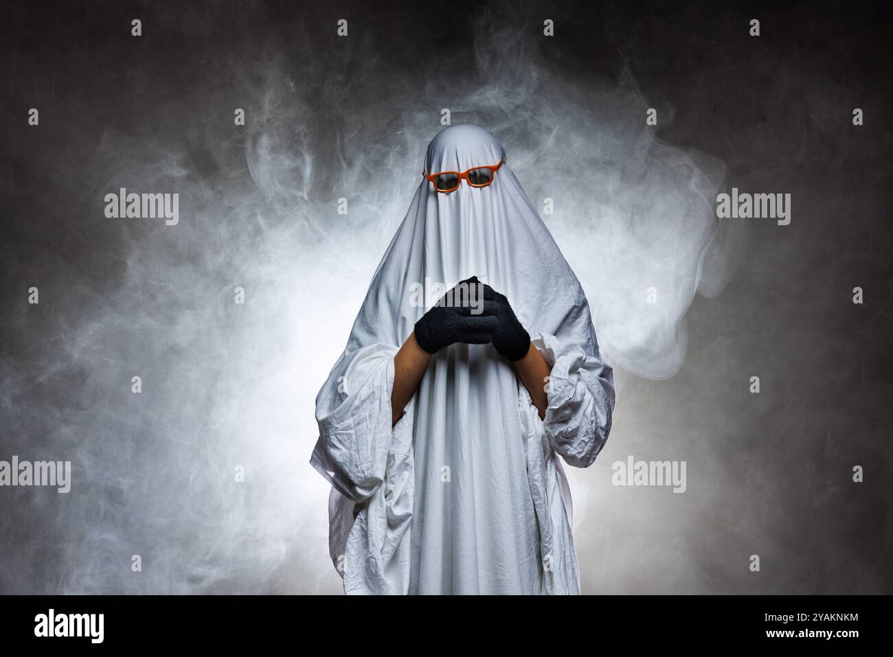 man in scary ghost costume in smoke on grey mysterious background in ...