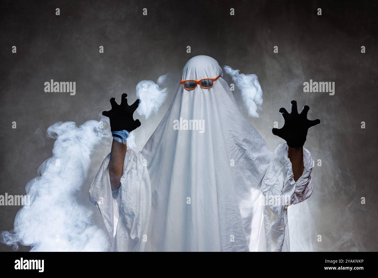 man in scary ghost costume in smoke on grey mysterious background in ...