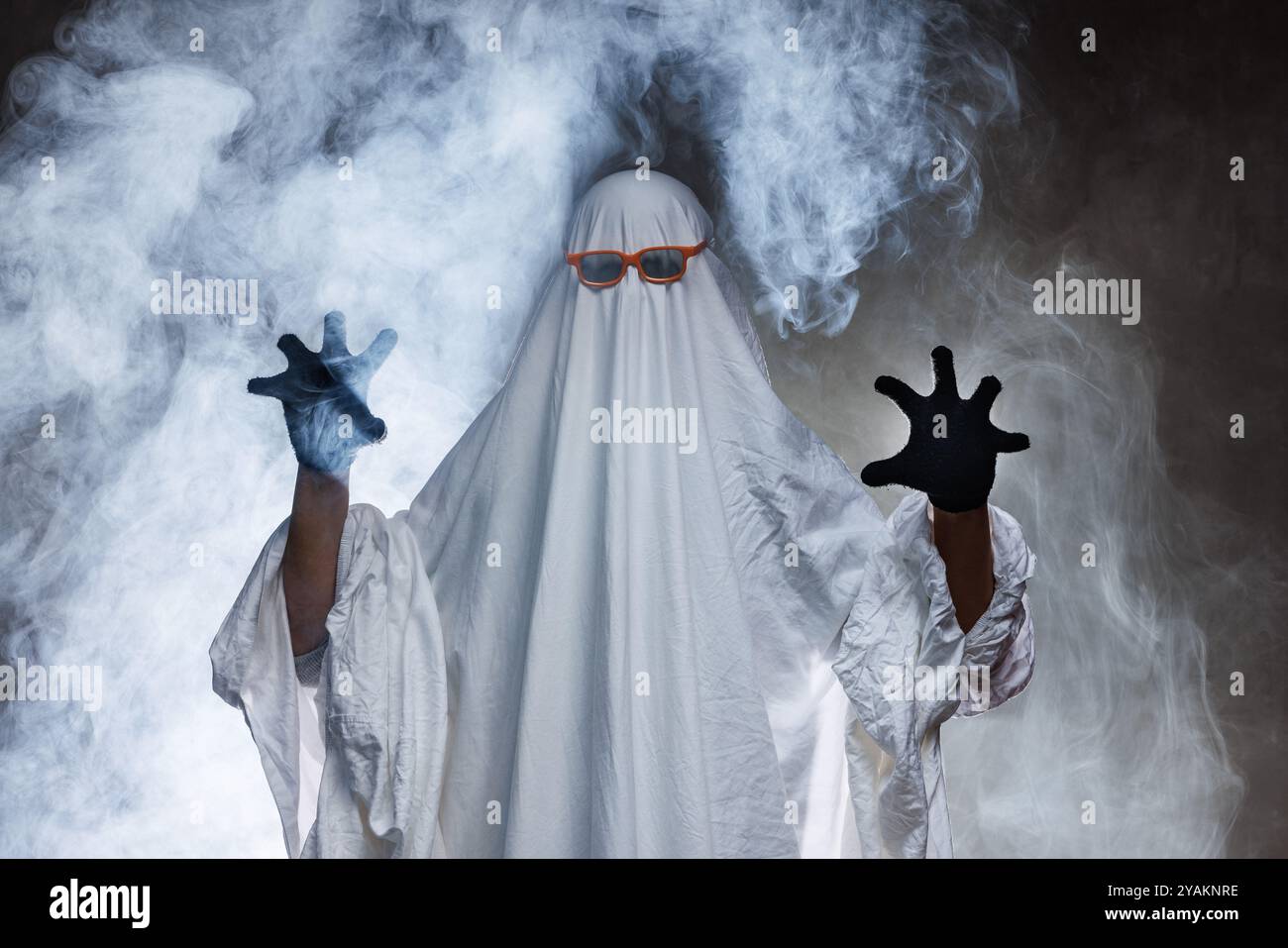 man in scary ghost costume in smoke on grey mysterious background in ...