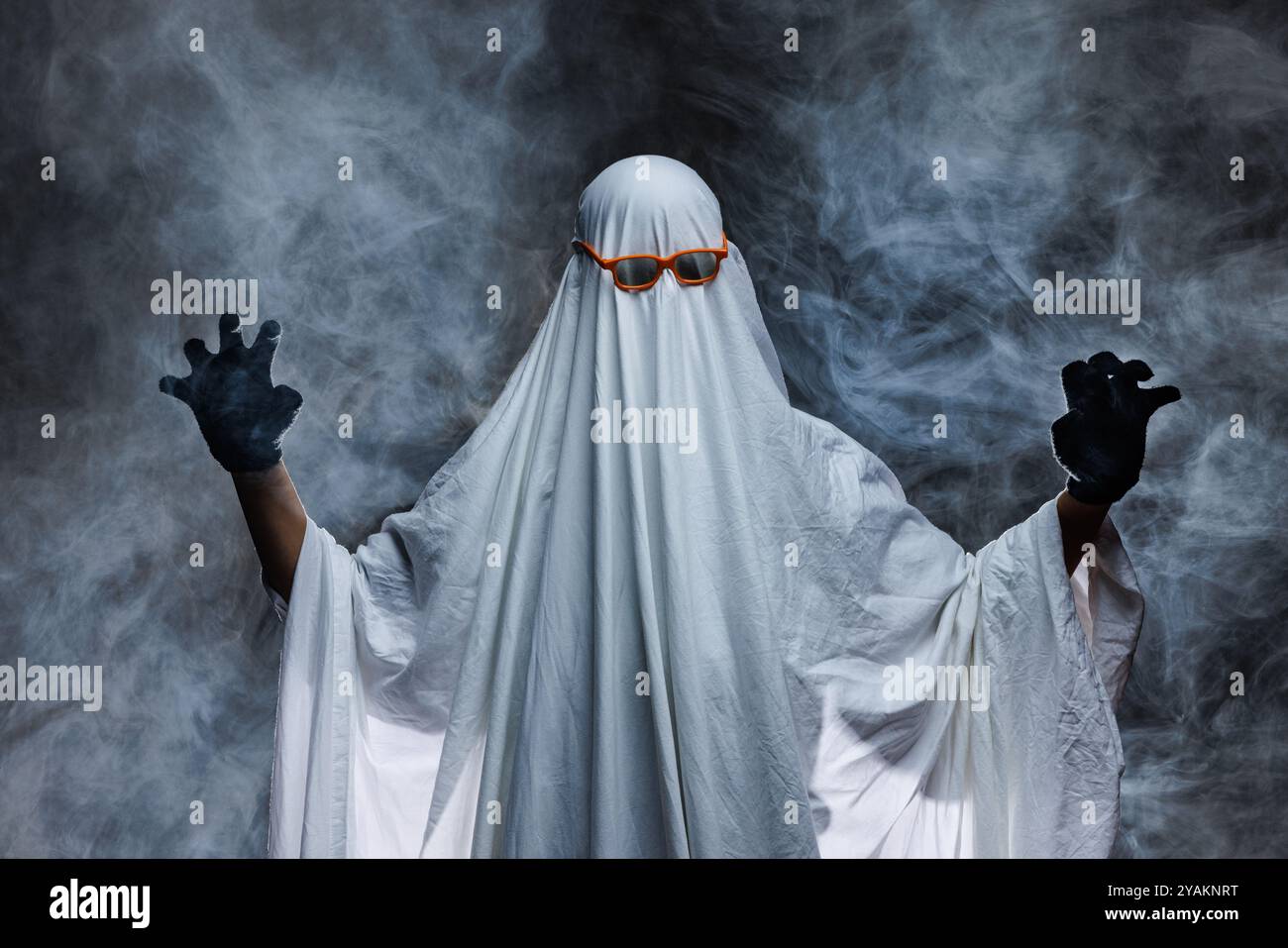 man in scary ghost costume in smoke on grey mysterious background in ...