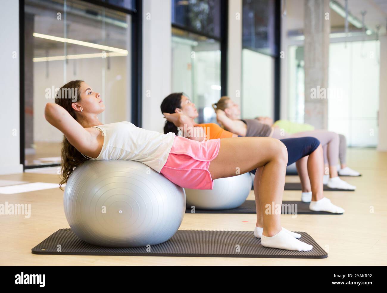 Women doing crunches on stability balls Stock Photo - Alamy