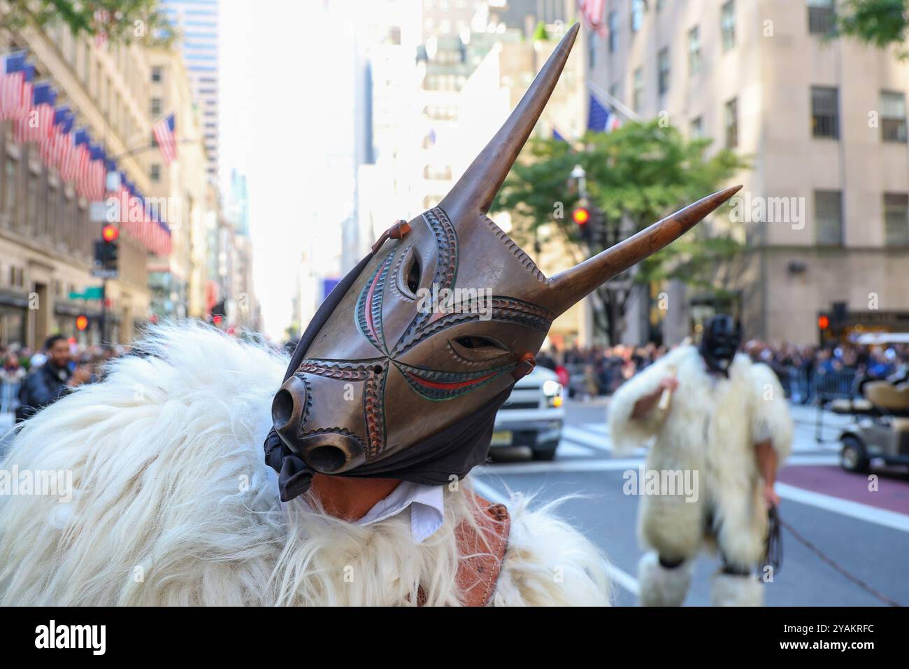 Performers in costume pose for a photo during the Columbus Day Parade ...