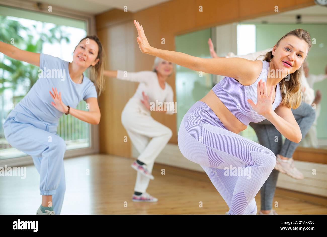 Group are practising arch movement in step jazz dance in fitness gym ...