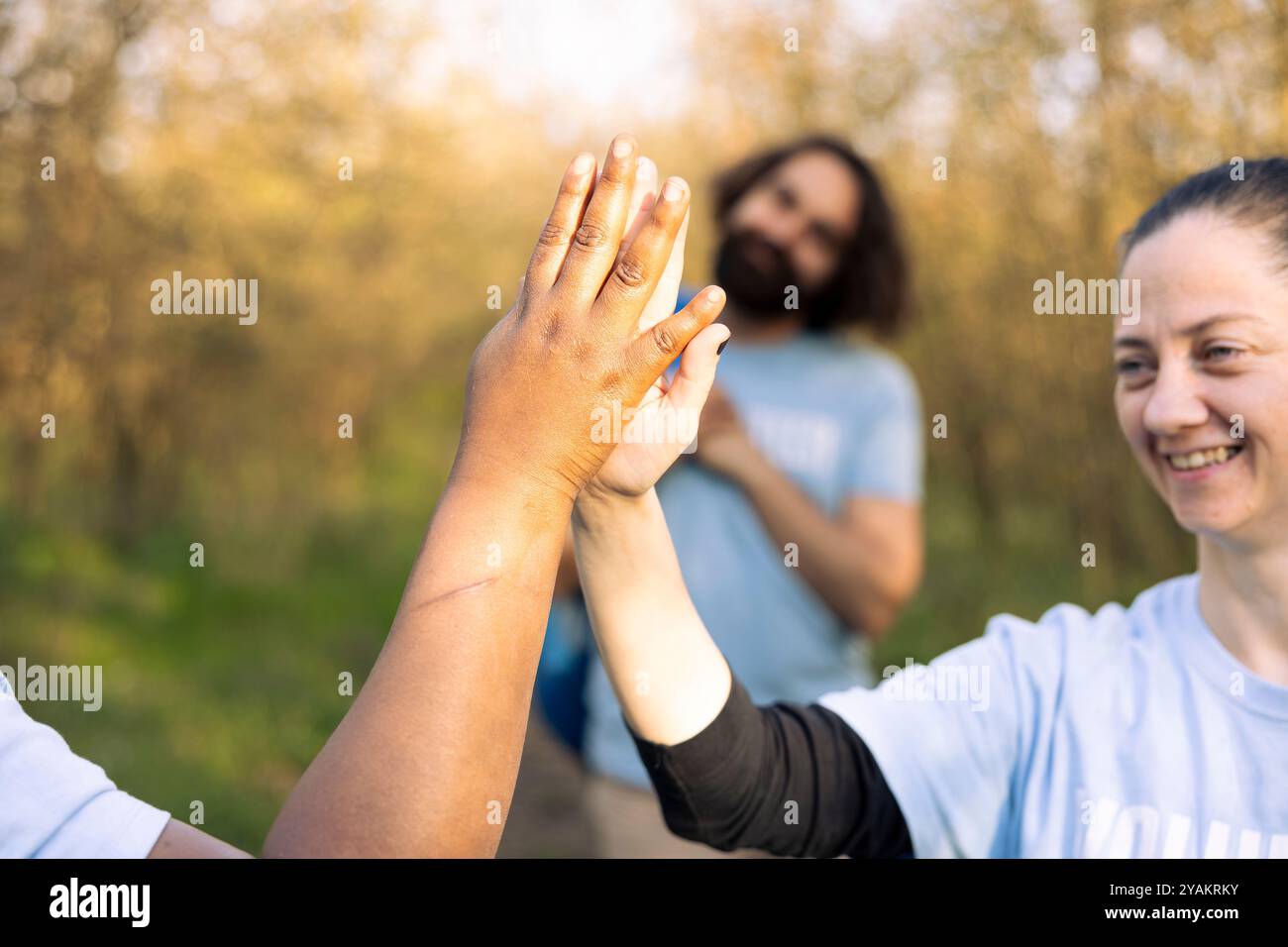 Happy team of environmentalists share high five with each other, saying ...