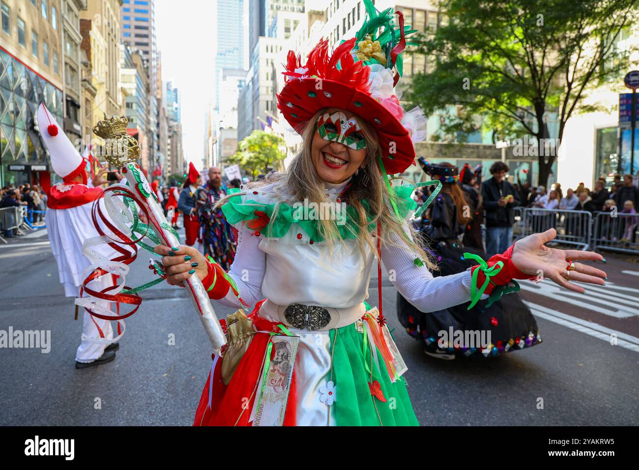 Performers in costume pose for a photo during the Columbus Day Parade ...