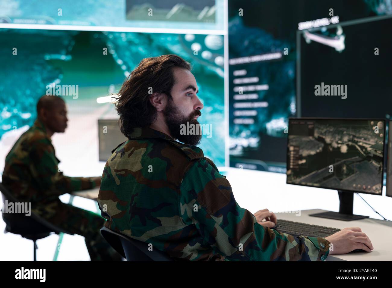 Military trooper gathering real time information from radar CCTV system, working on ...