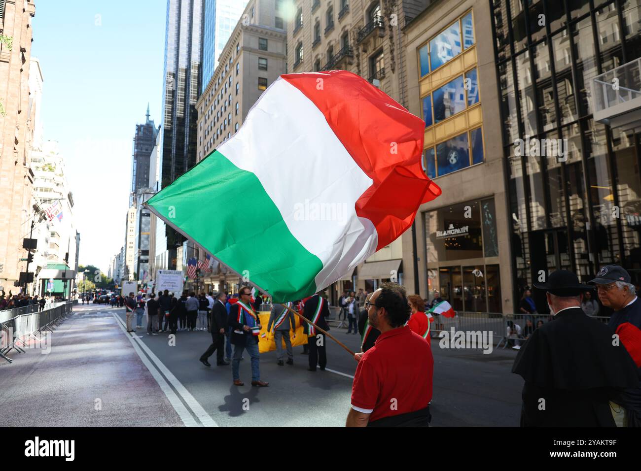 Participants wave flags as they march up 5th Avenue in the Columbus Day ...
