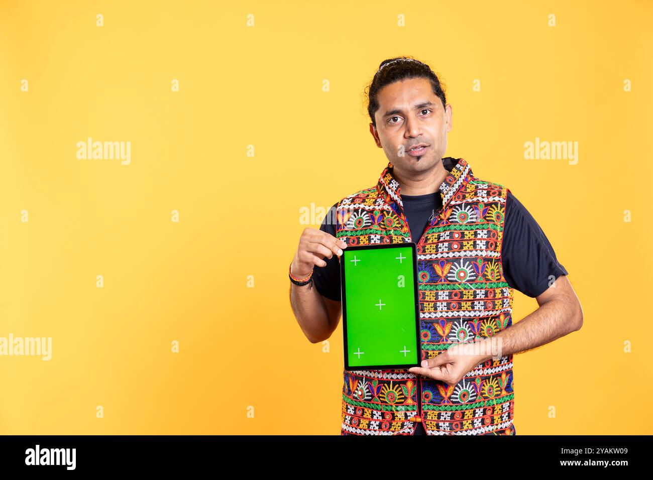 Portrait of influencer presenting green screen tablet for tech ...