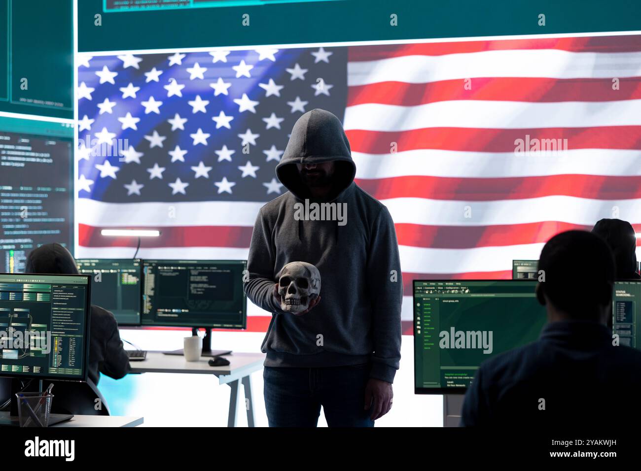 American man in a dark hood making death threats with human skull ...