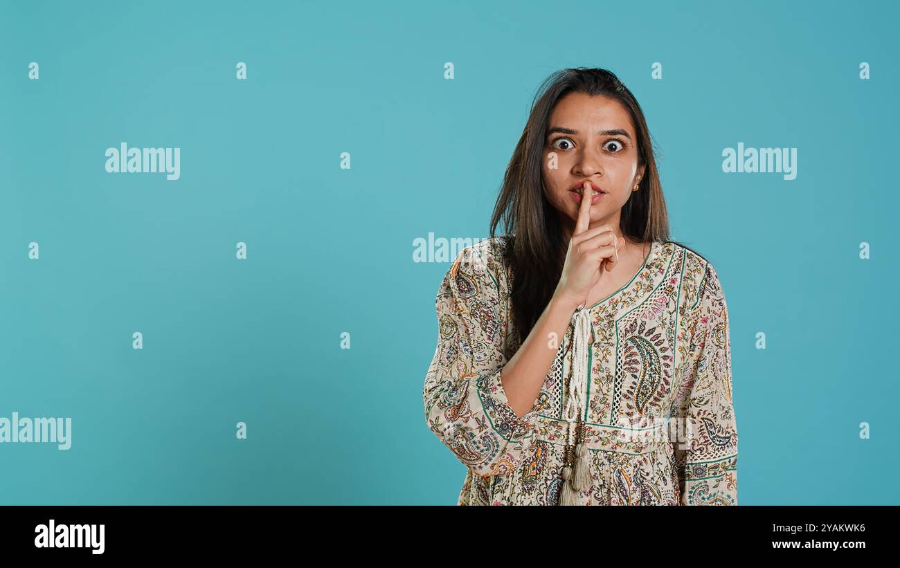 Annoyed indian woman doing shushing hand gesturing, irritated by noise ...