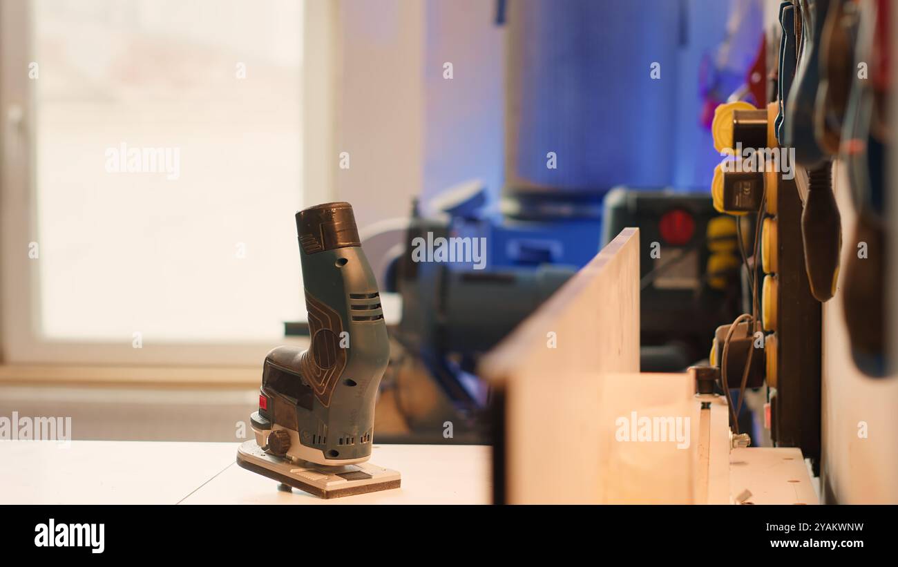 Close up of electric router on workbench in assembly shop with ...