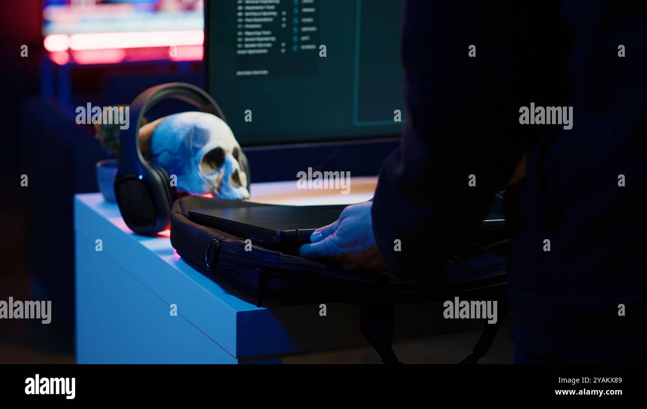 Hacker taking laptop out of suitcase, prepared to launch DDoS attack ...