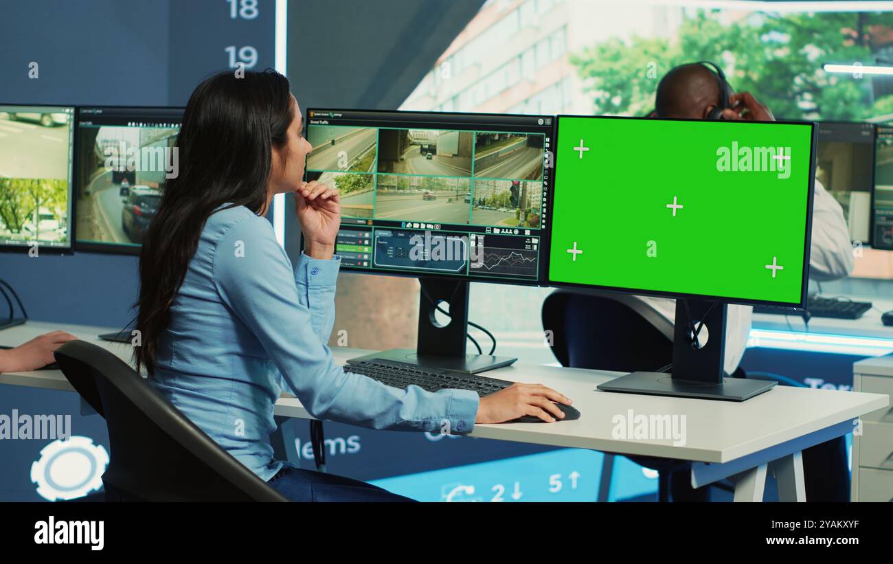 Indian woman working with surveillance footage and greenscreen on ...