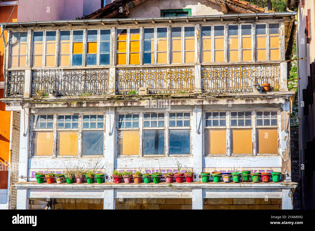 A view of a rustic, weathered balcony and facade typical of fishing ...