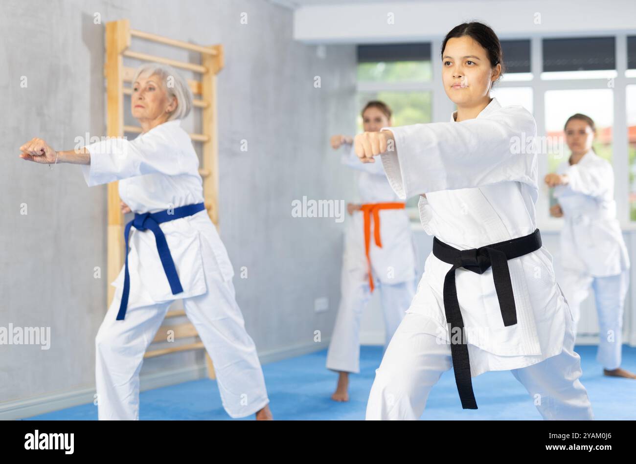Asian woman in kimono performing kata routines during group karate ...