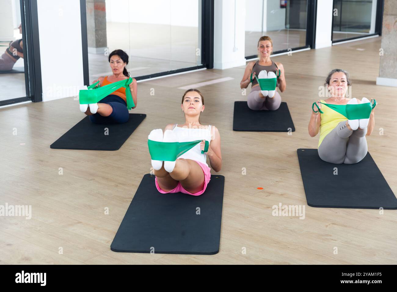 Group of women doing stretch exercises Stock Photo - Alamy