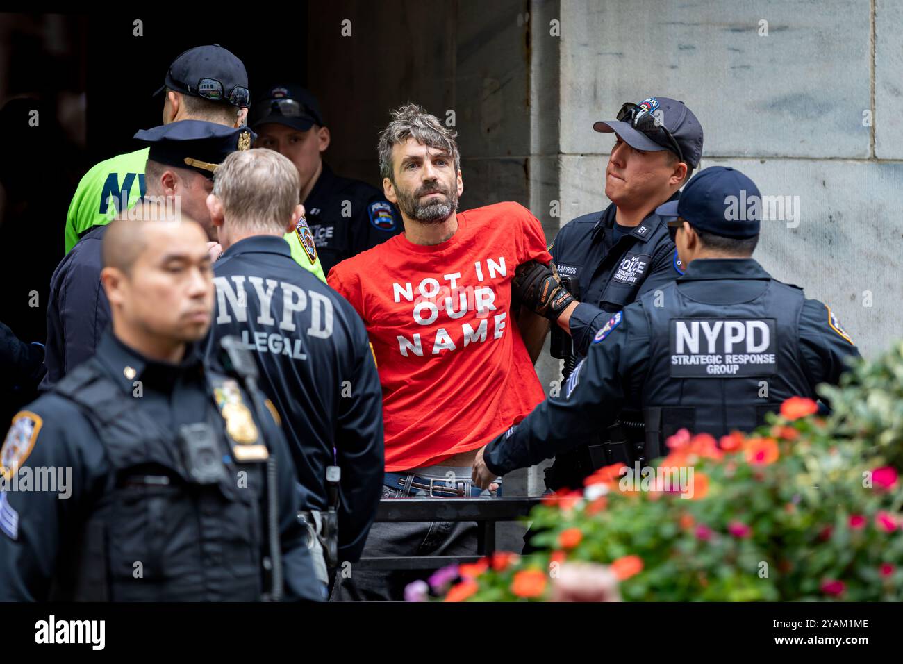 NEW YORK, NEW YORK - OCTOBER 14: An arrested protester is escorted away ...
