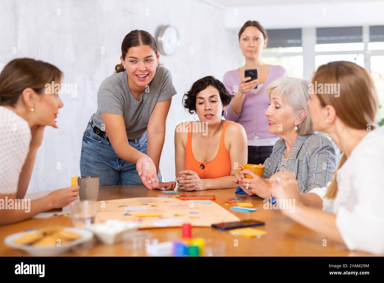 Group of of different years people playing tabletop game Stock Photo ...
