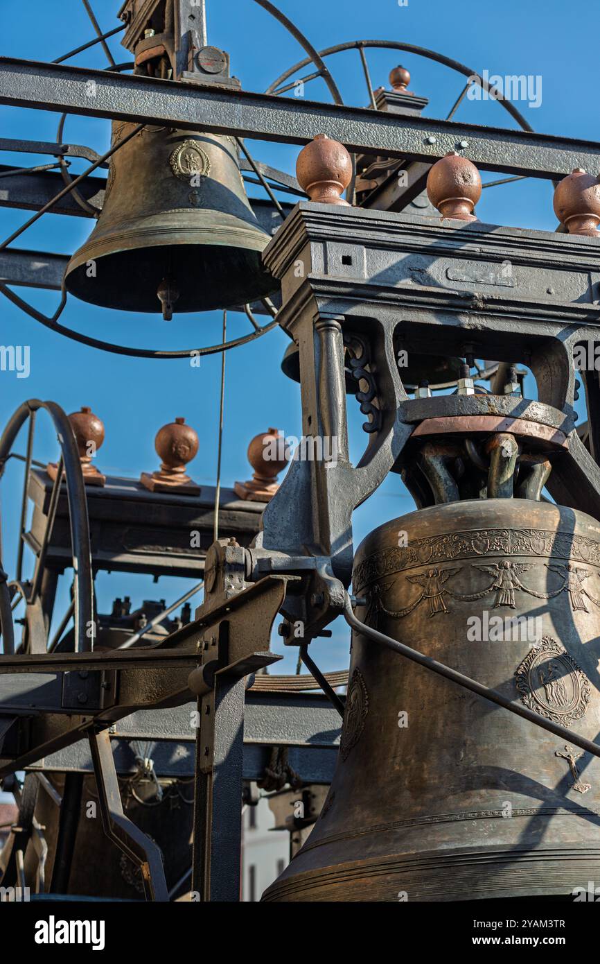 Large, heavy, ancient church bells are mounted high on a steel frame ...