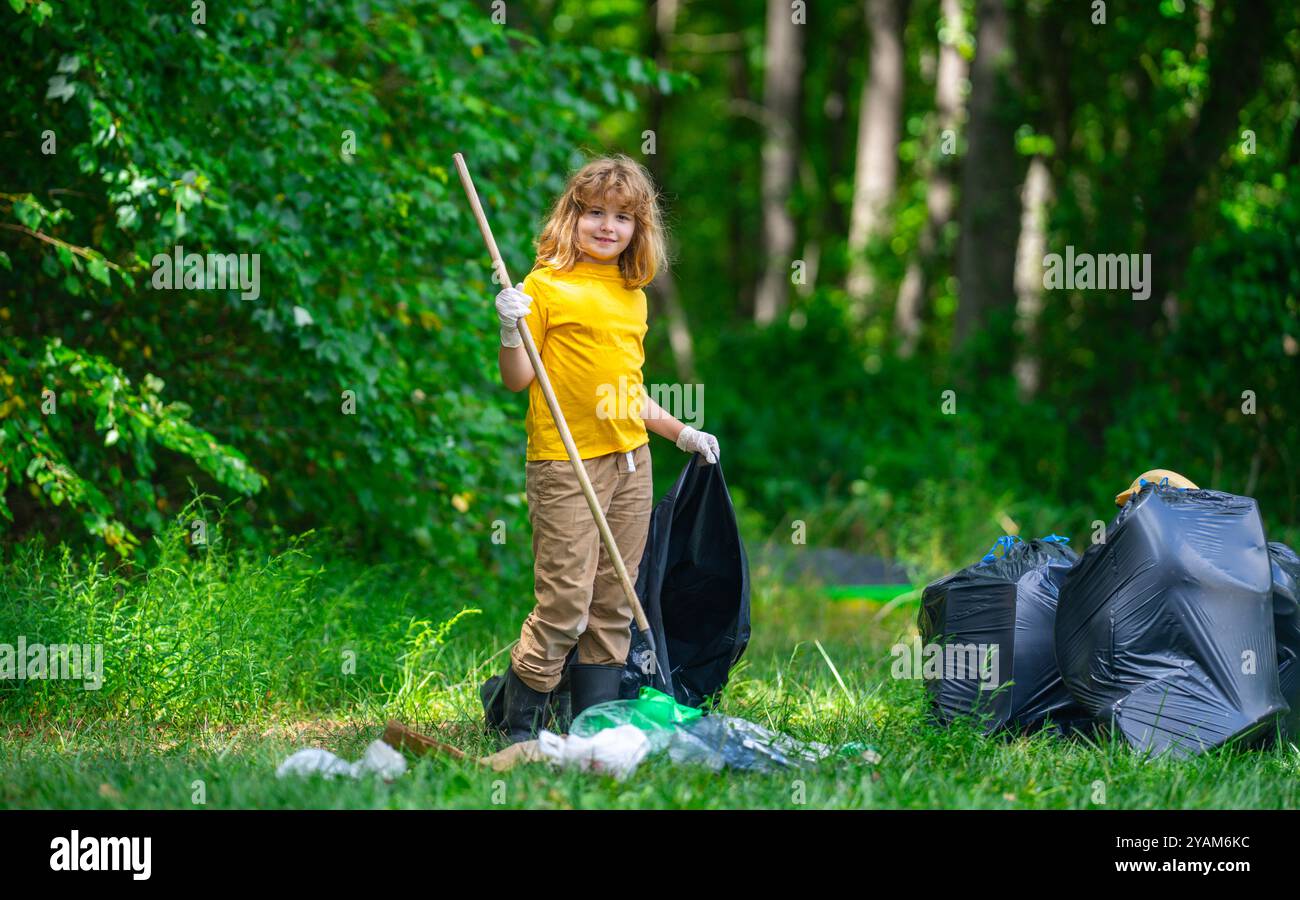 Kid cleaning up the park, putting trash in a garbage bag. Environmental ...