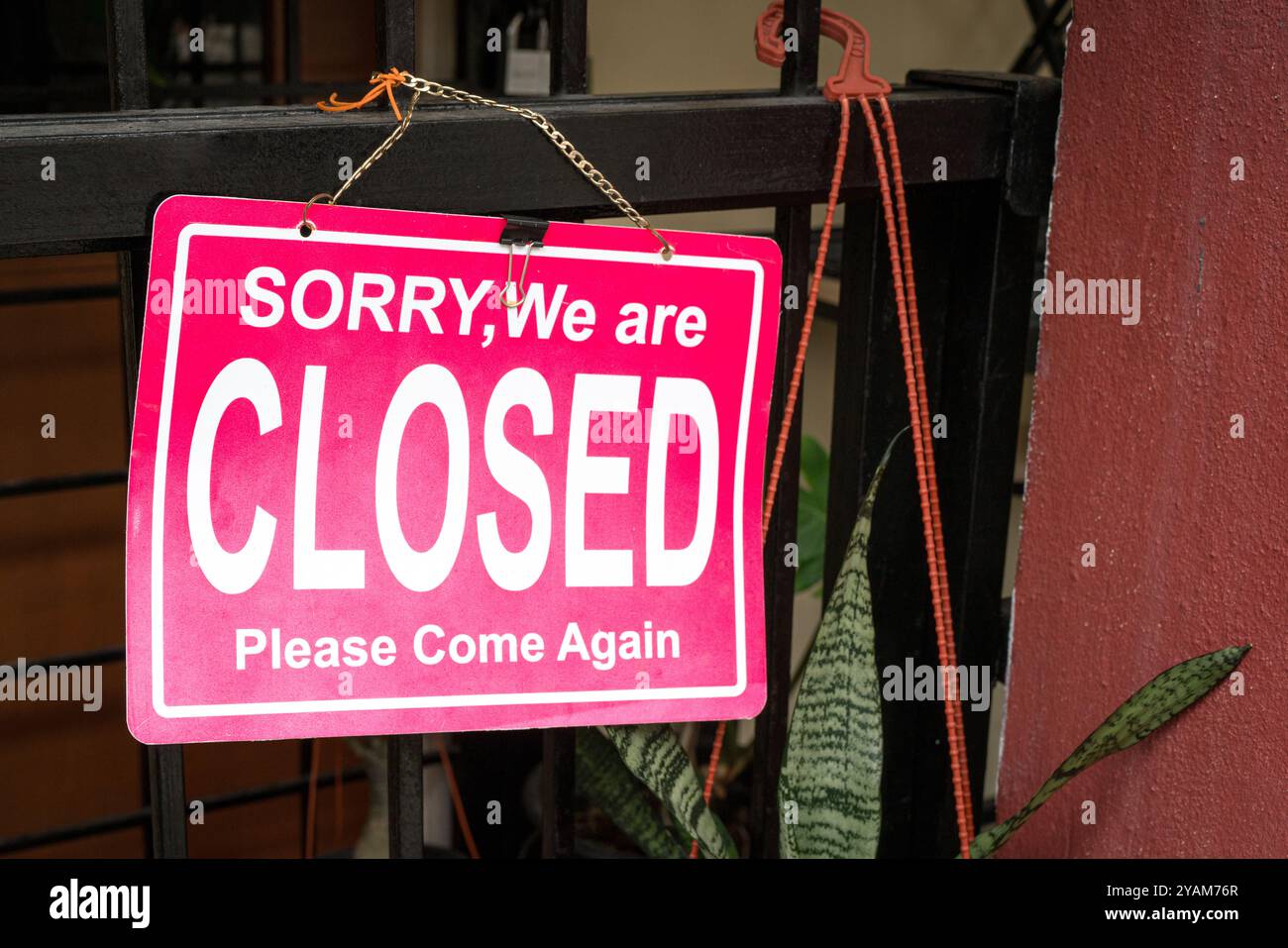 Sorry, We are Closed signboard, tied to a gate of a shop Stock Photo ...